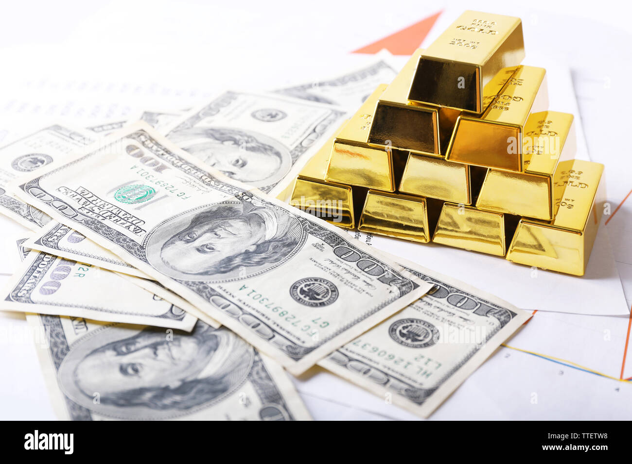 Gold bars with dollar banknotes on paper background Stock Photo - Alamy