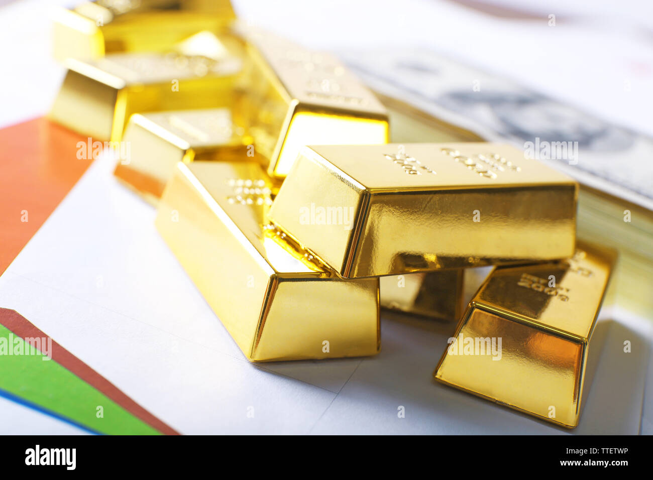 Gold bars with dollar banknotes on paper background Stock Photo - Alamy