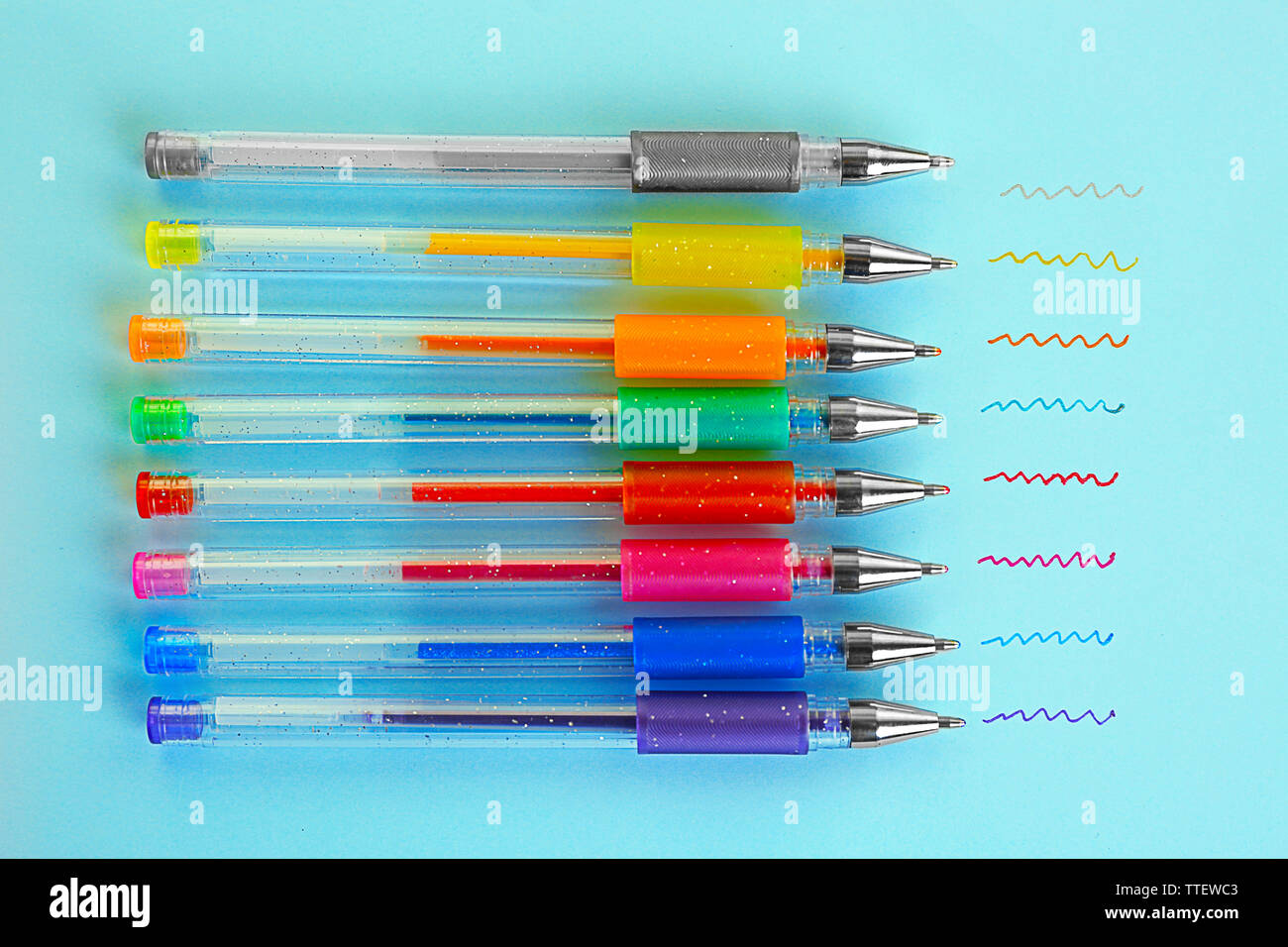 Set of colored pens on blue paper Stock Photo - Alamy