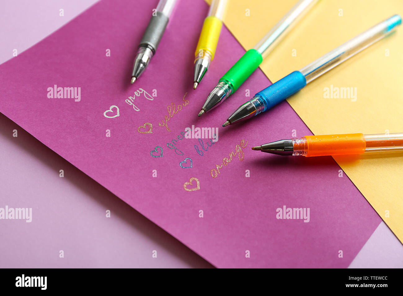 Set of colored pens on paper background Stock Photo - Alamy