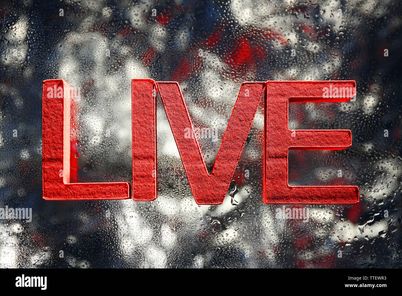 Live inscription with red letters on a wet lightened glass Stock Photo ...