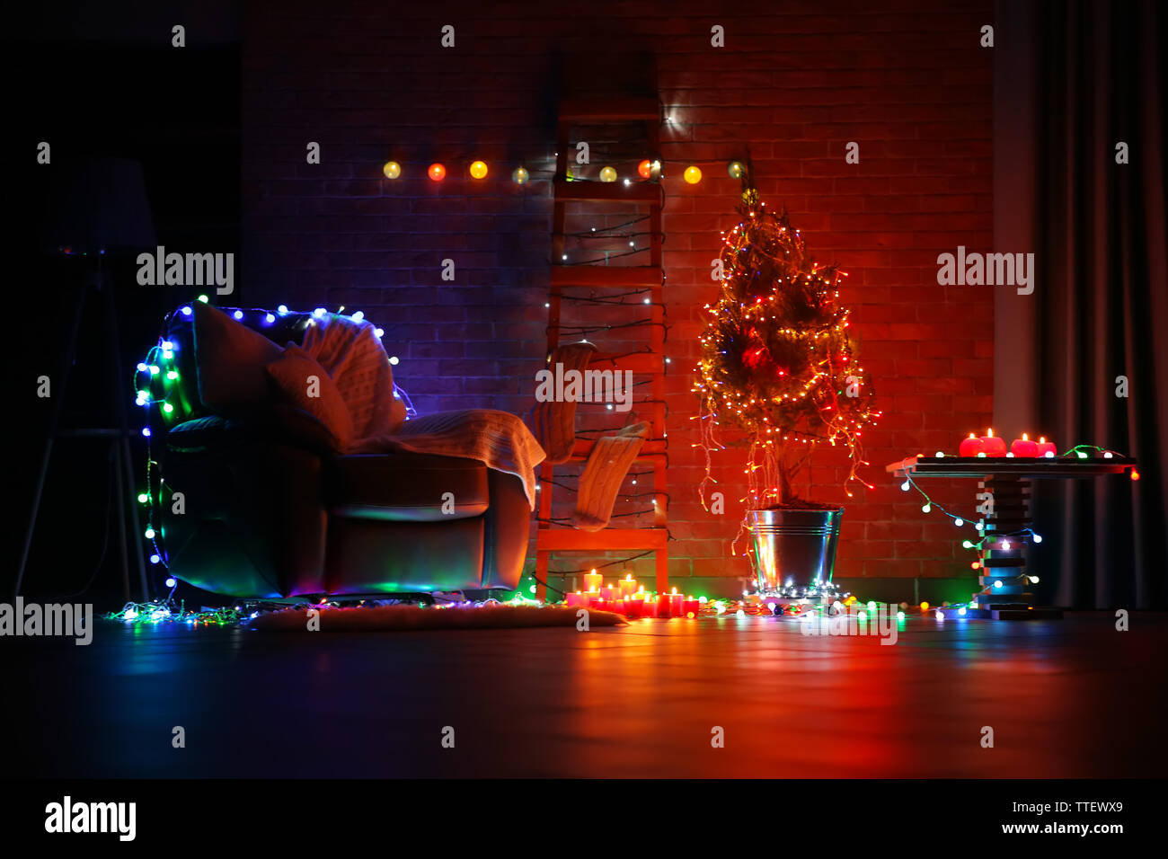 Christmas tree and other decor in dark room Stock Photo - Alamy