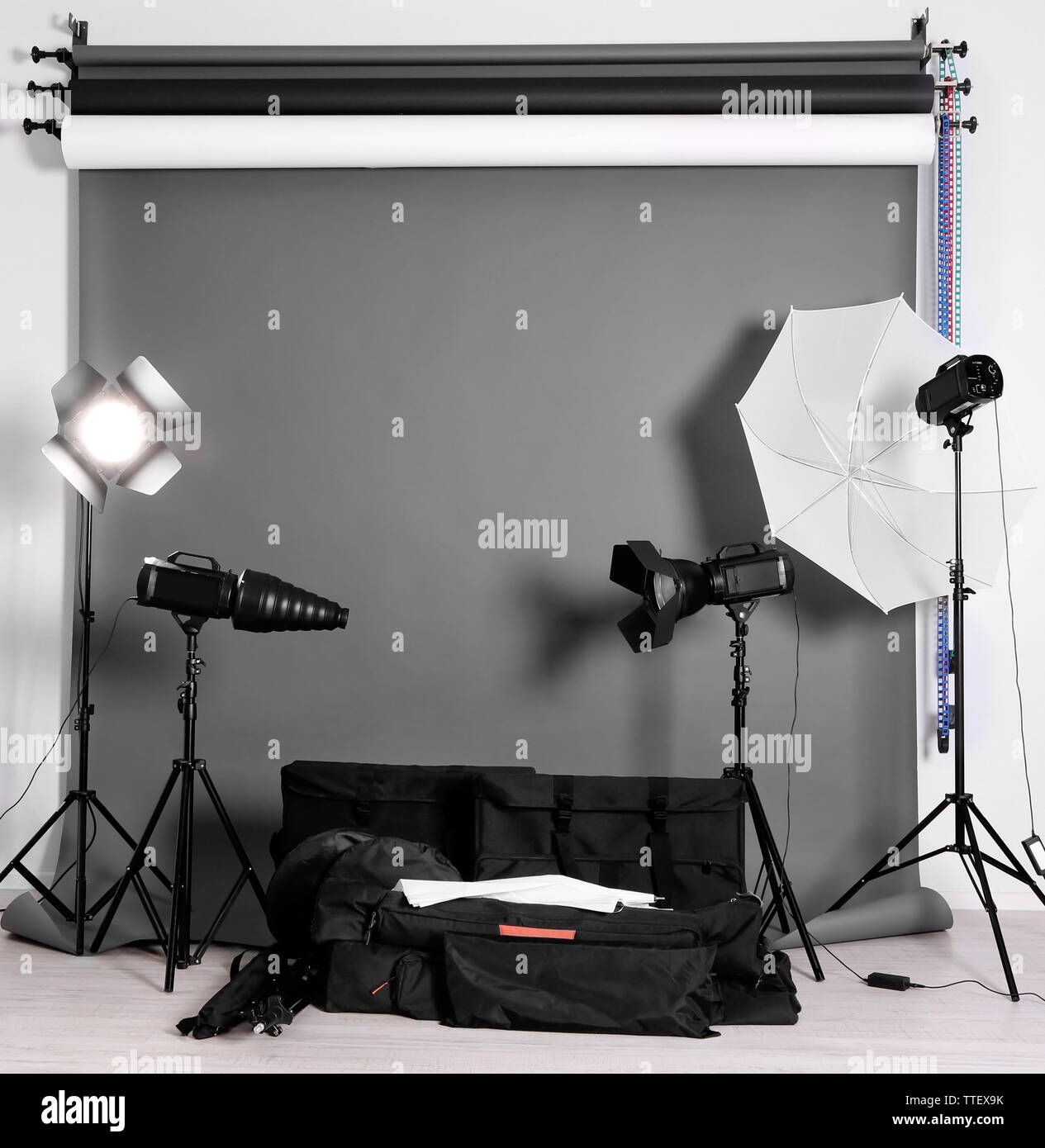 Empty photo studio with lighting equipment, bags and backdrop Stock ...