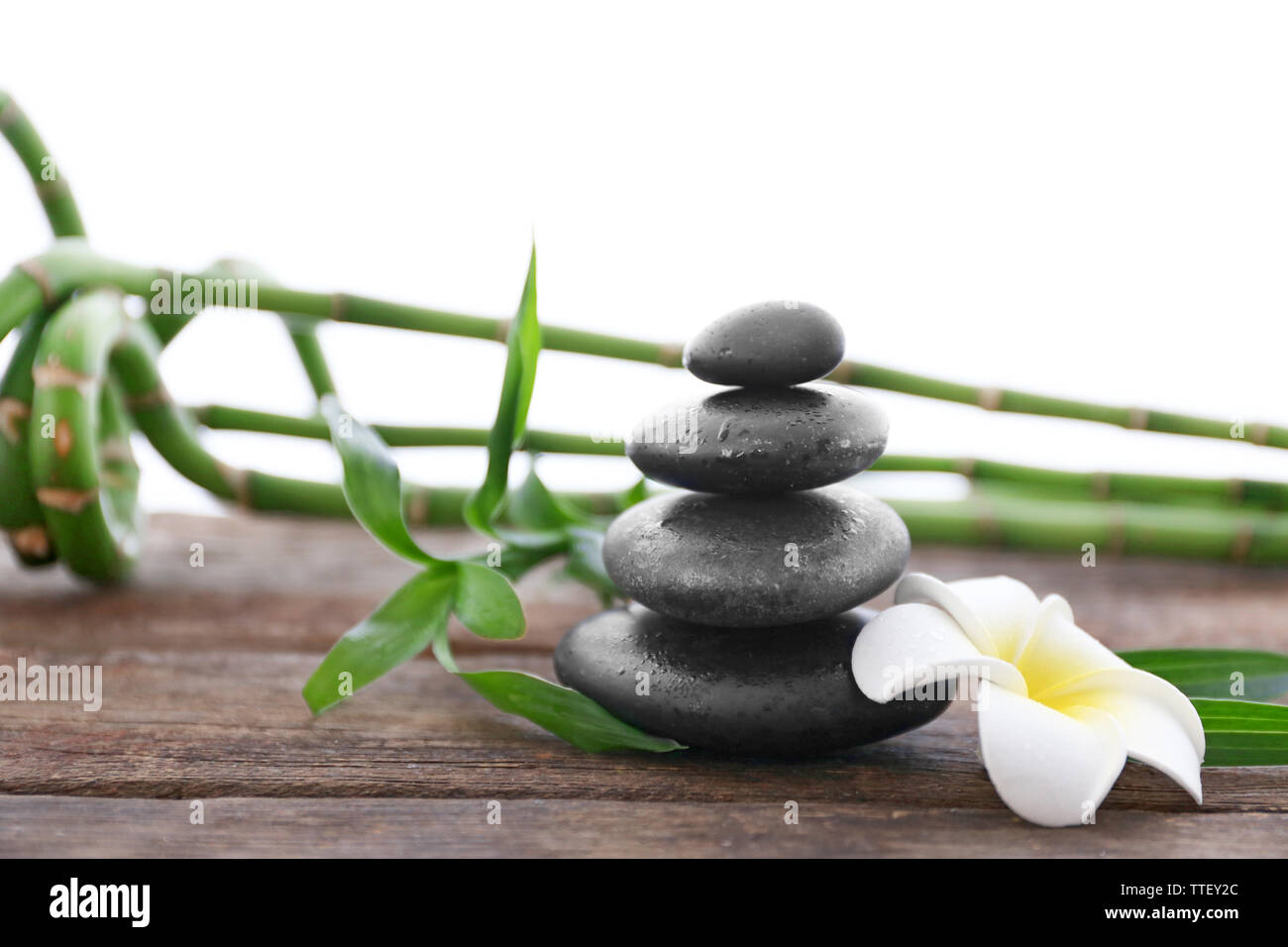 Spa stones with bamboo and tropical flower on white background Stock ...