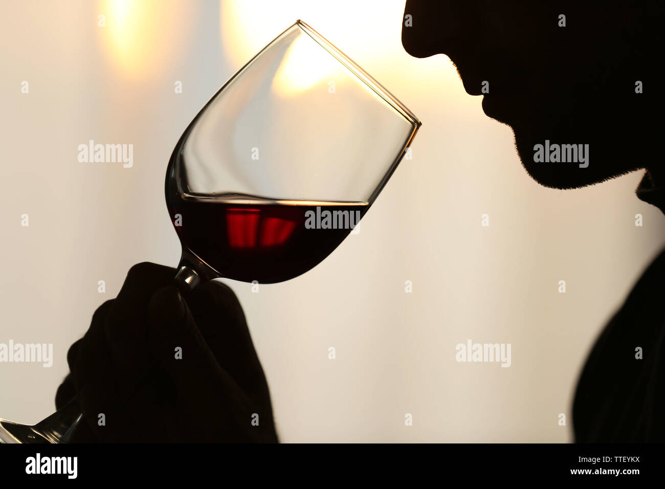 Silhouette of man sniffing red wine in a glass, close up Stock Photo ...