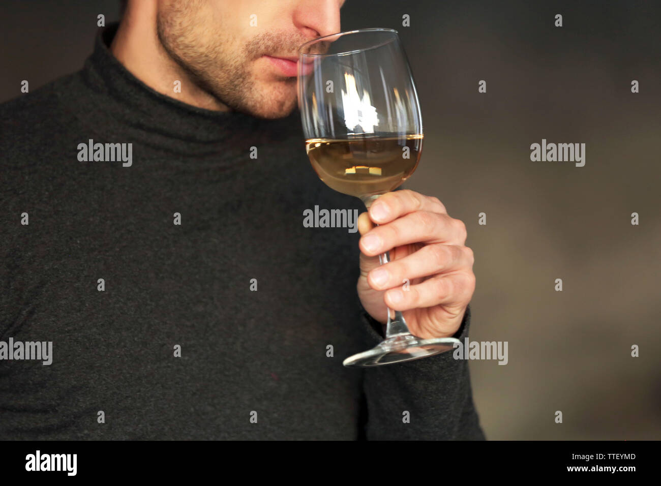 Man sniffing white wine in a glass, close up Stock Photo - Alamy