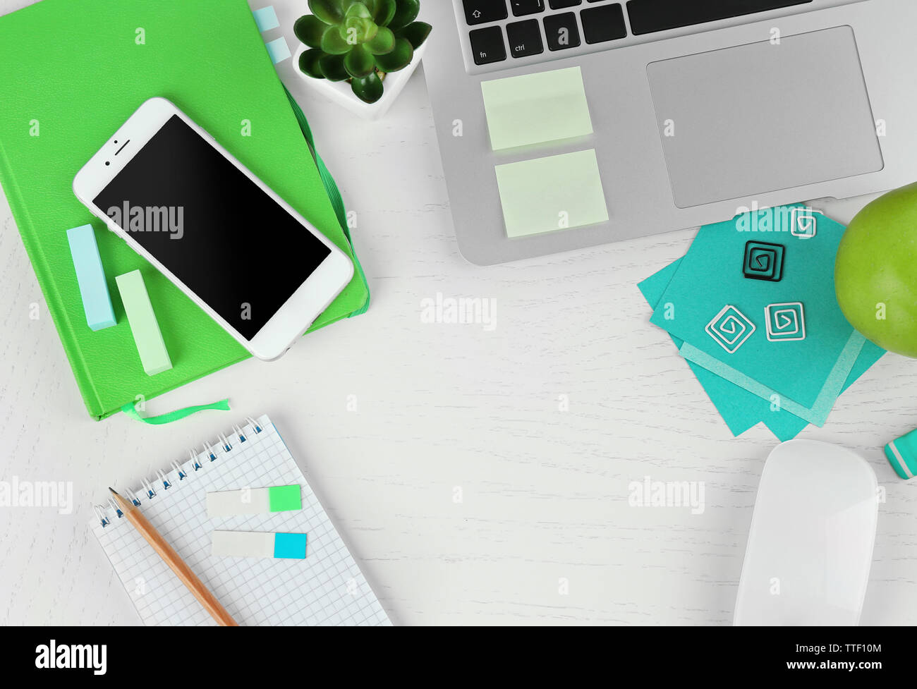 Workplace with mobile phone, computer peripherals and stationery on ...