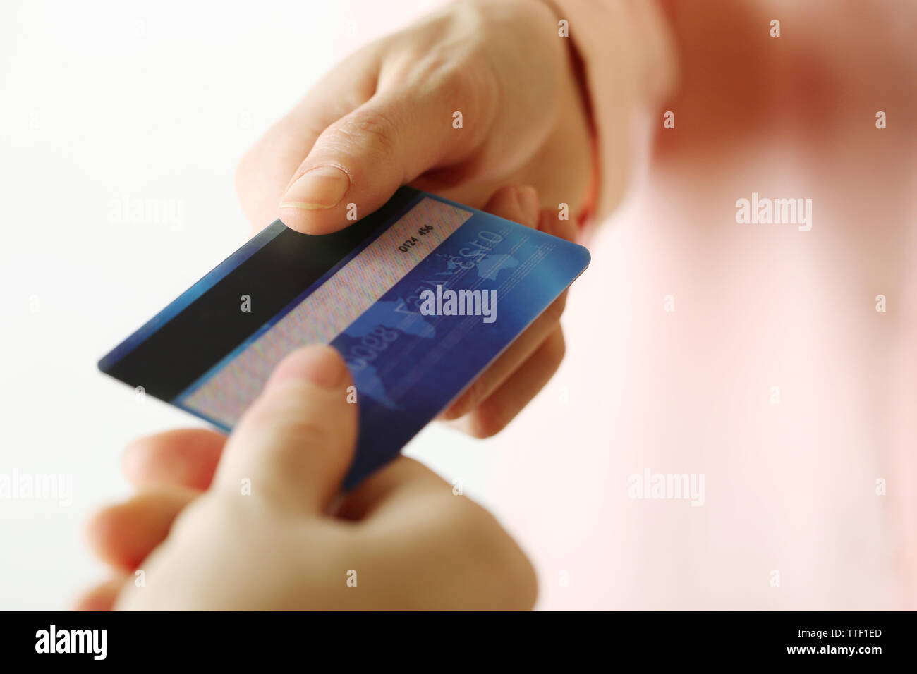 Hands holding blue credit card on white background Stock Photo - Alamy