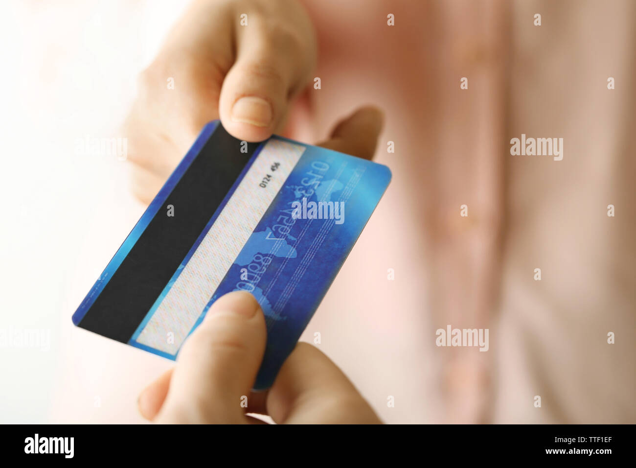 Hands holding blue credit card on white background Stock Photo - Alamy