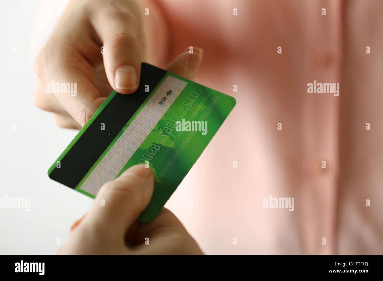Hands holding green credit card on white background Stock Photo - Alamy