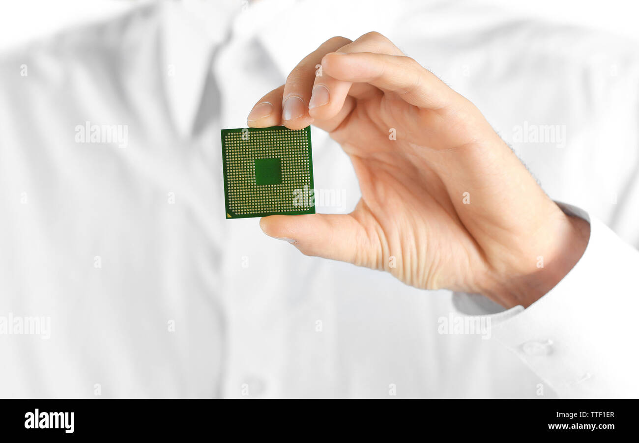 Man holding microprocessor in his hand on white background Stock Photo ...