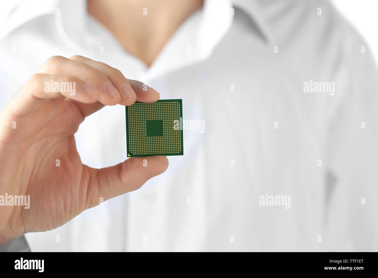 Man holding microprocessor in his hand on white background Stock Photo ...