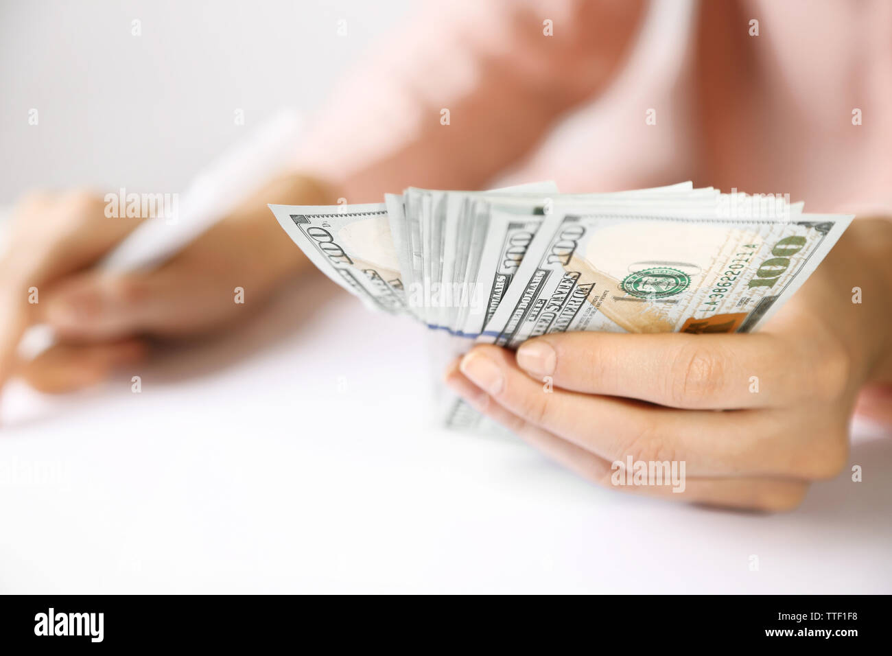 Hand holding dollar banknotes on white background Stock Photo - Alamy