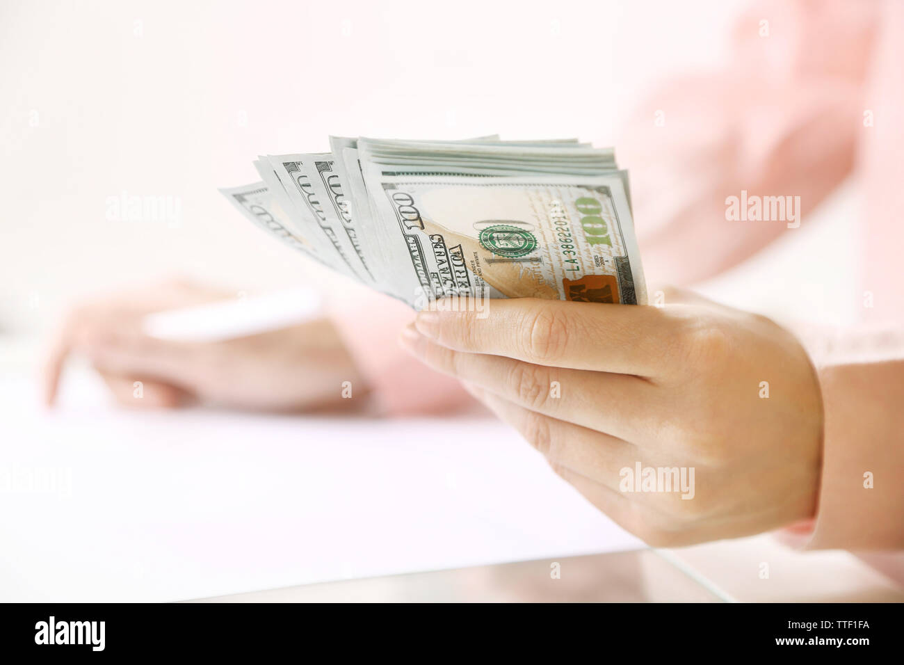 Hand holding dollar banknotes on white background Stock Photo - Alamy