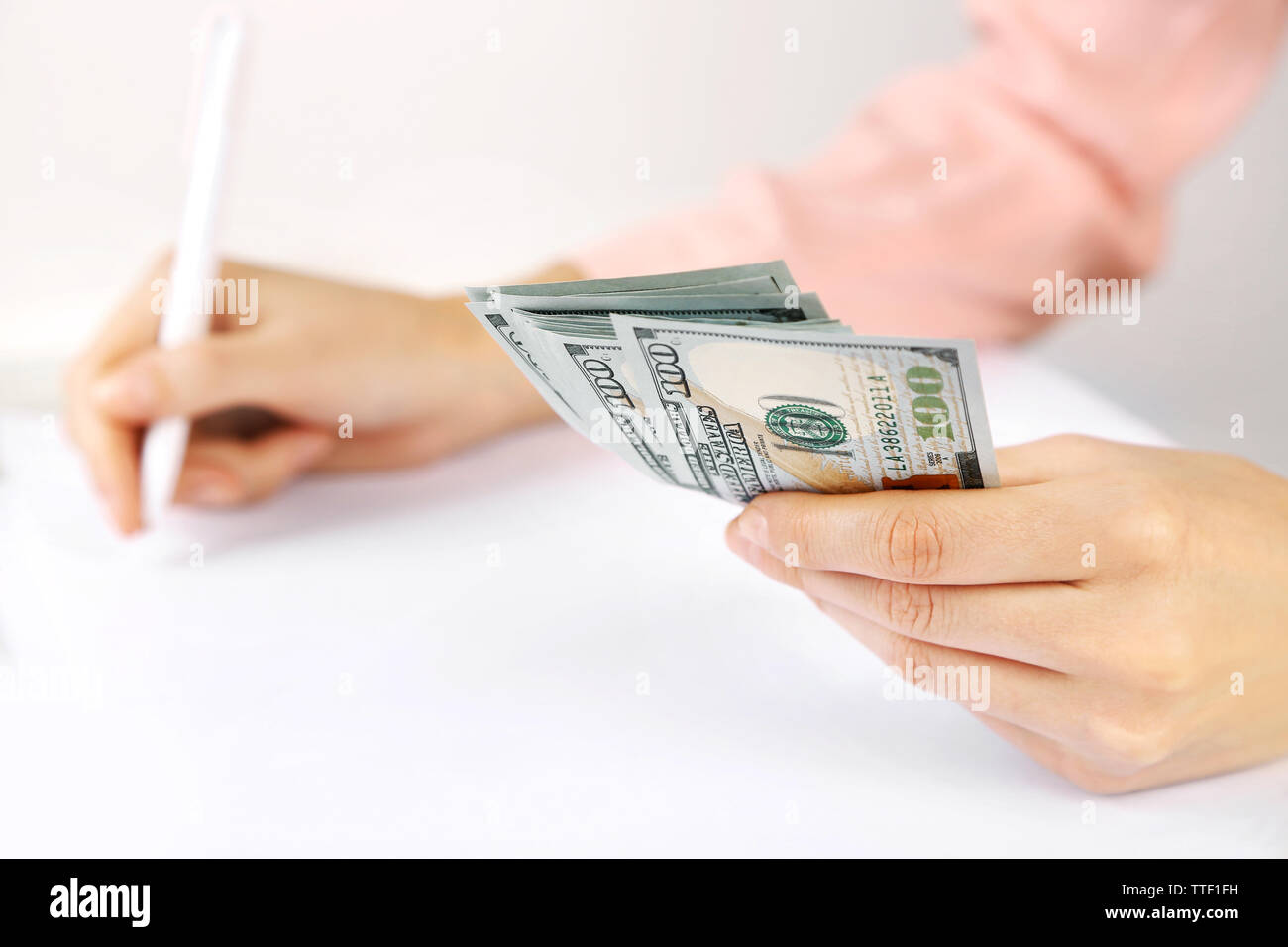 Hand holding dollar banknotes on white background Stock Photo - Alamy
