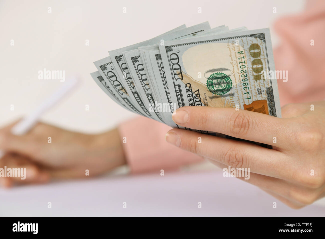 Hand holding dollar banknotes on white background Stock Photo - Alamy