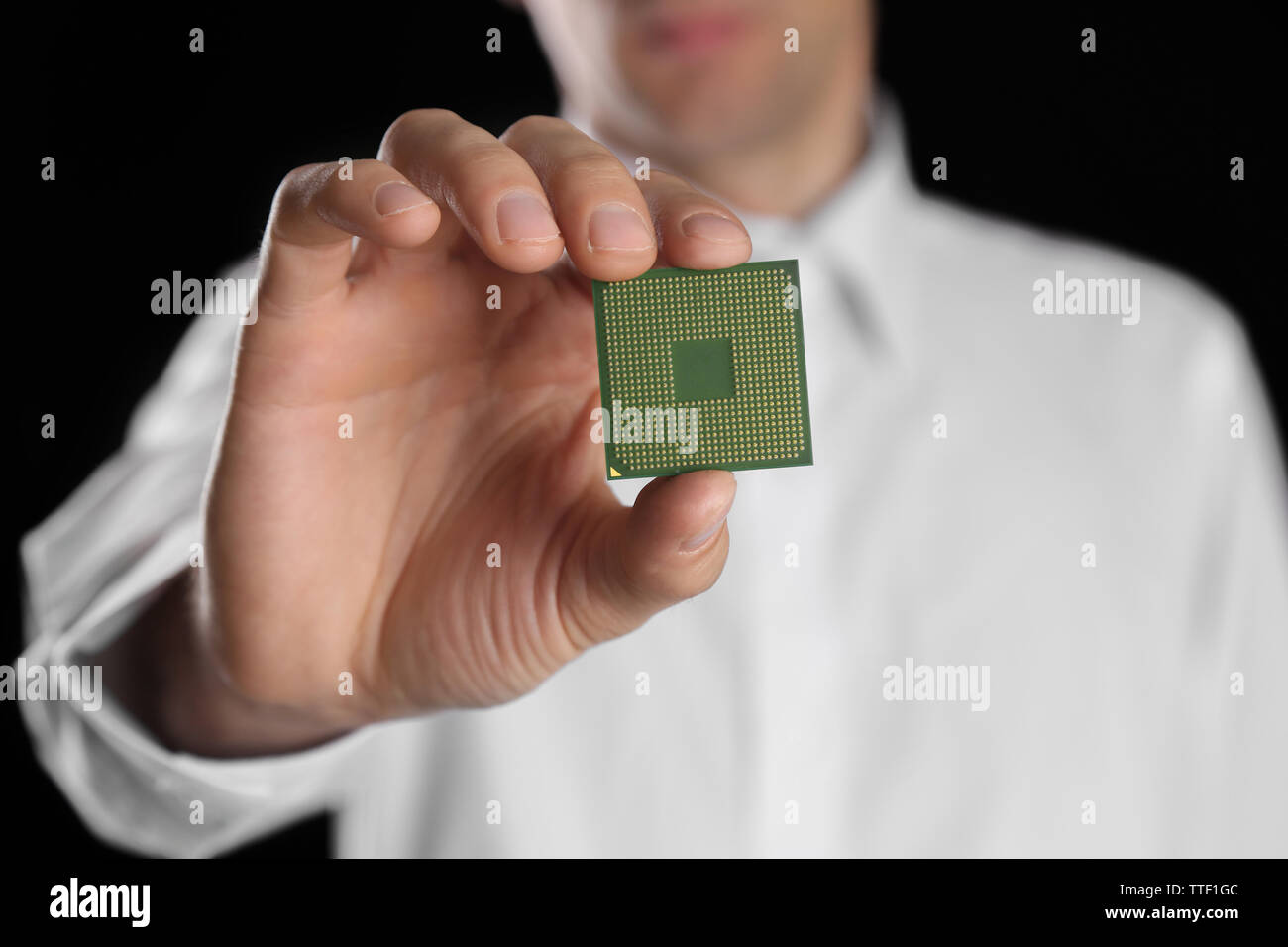 Man holding microprocessor in his hand on black background Stock Photo ...