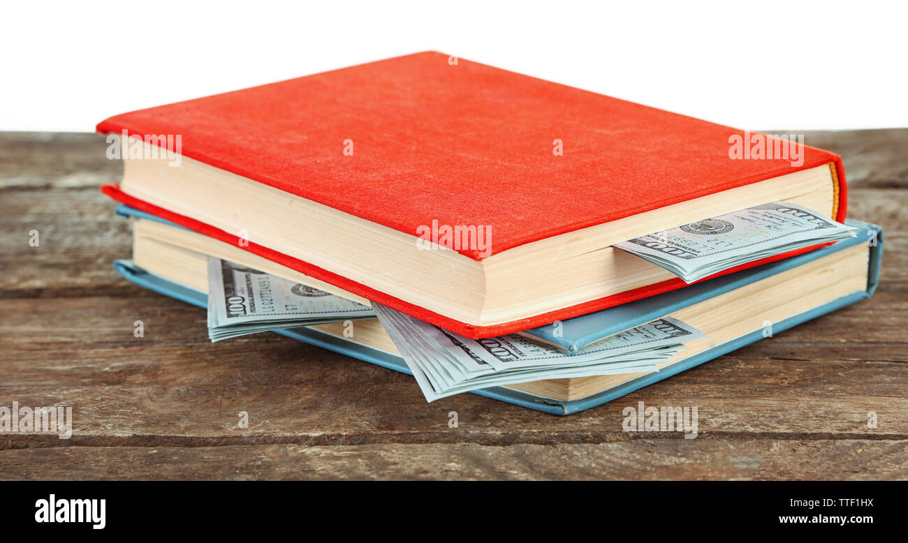 Books with nested dollar banknotes on white background. Stash of money ...