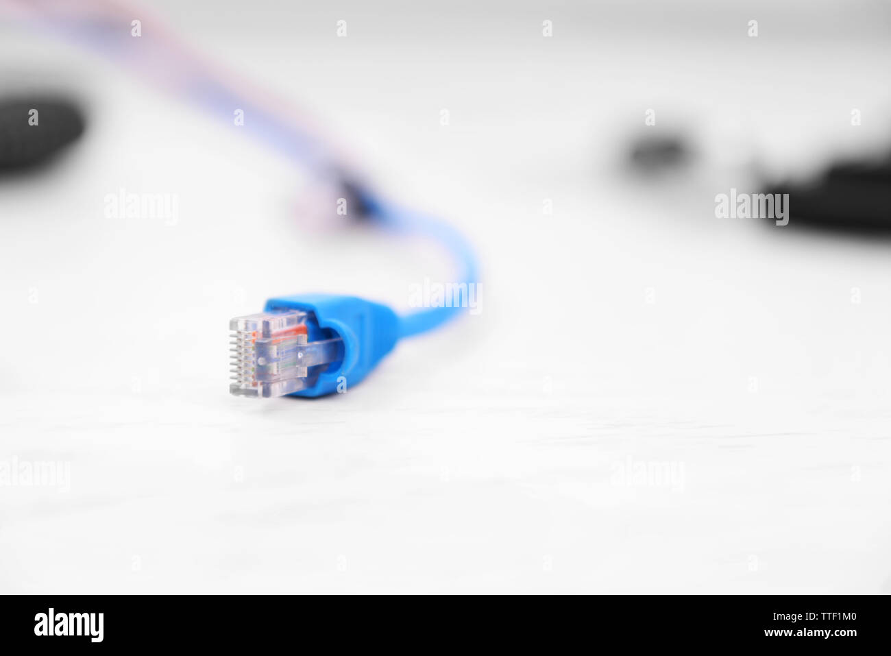 Connector of blue Ethernet cable on blurred white background Stock ...