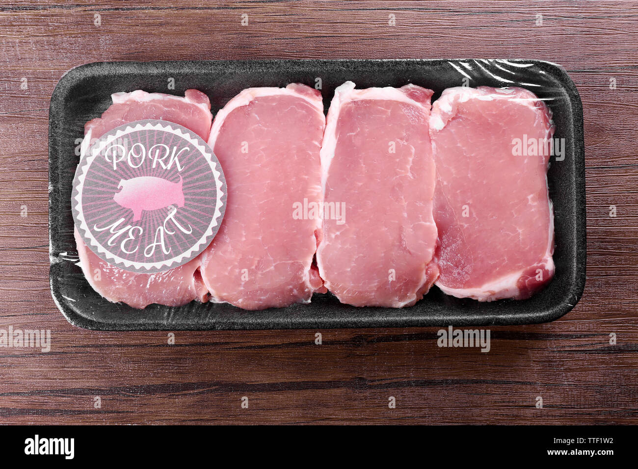 Packed pieces of pork meat on wooden background Stock Photo - Alamy