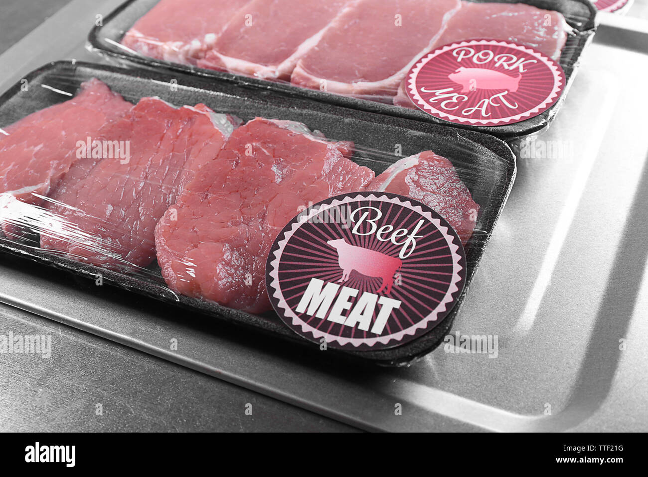 Packed pieces of pork and beef meat on metal background Stock Photo - Alamy