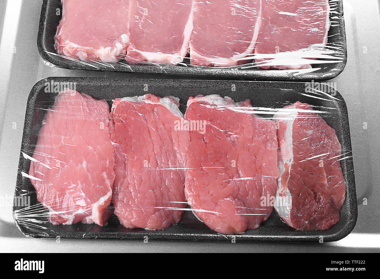 Packed pieces of pork and beef meat on metal background Stock Photo - Alamy