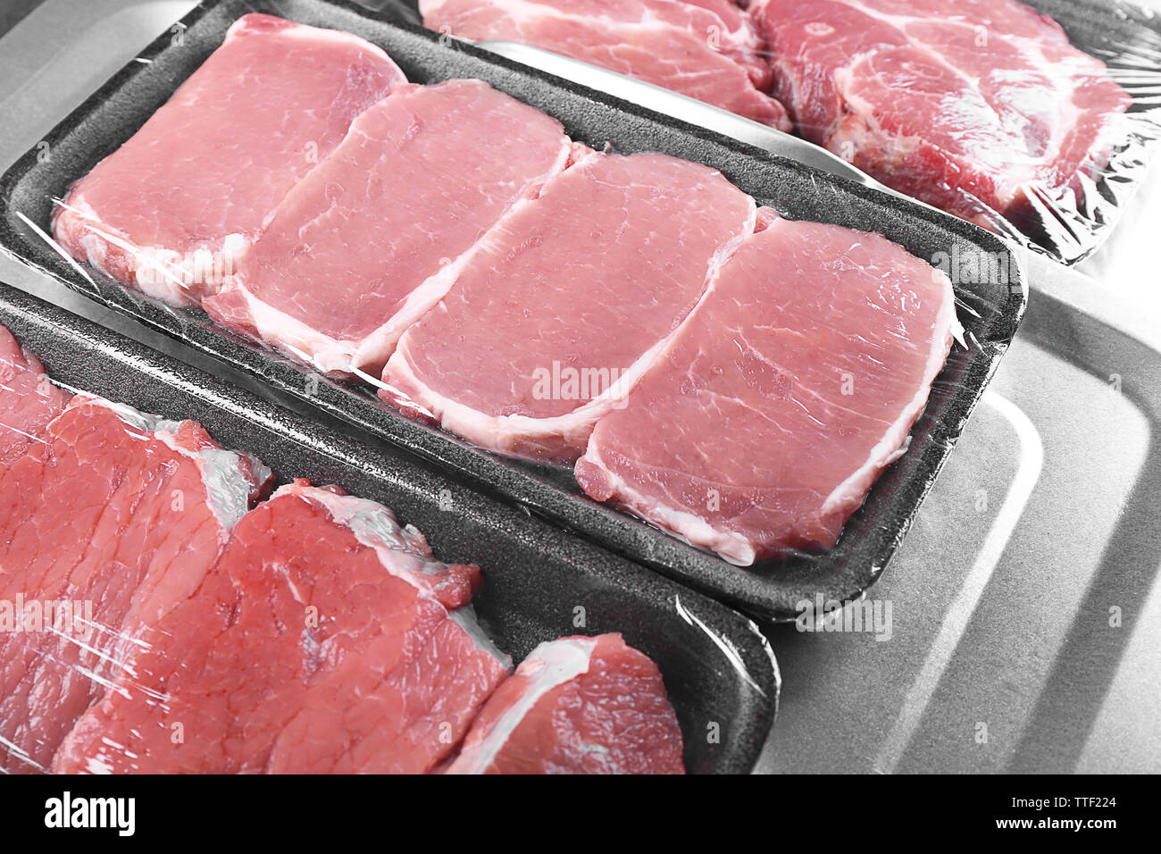 Packed pieces of pork and beef meat on metal background Stock Photo - Alamy