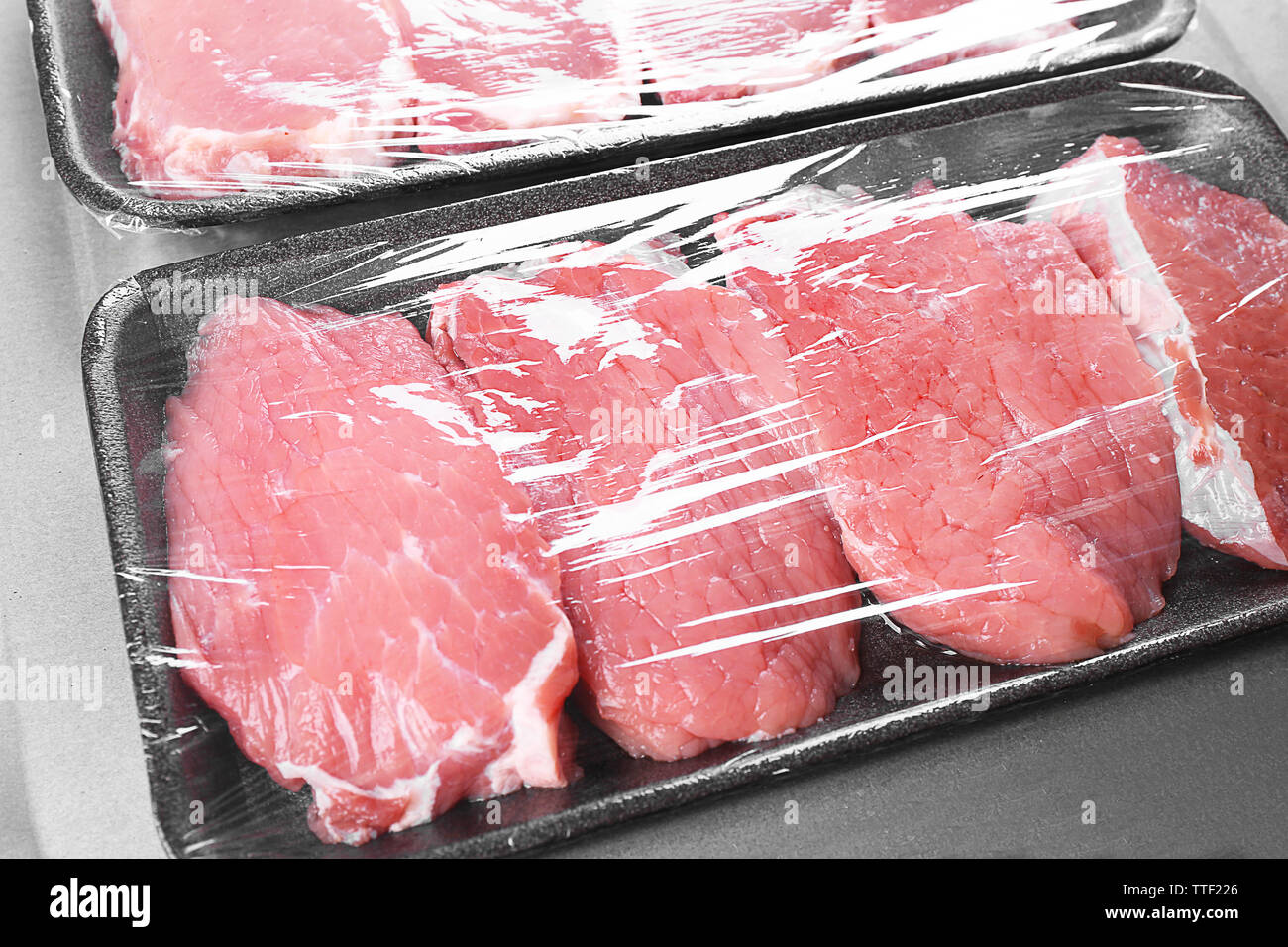 Packed pieces of beef meat on metal background Stock Photo - Alamy