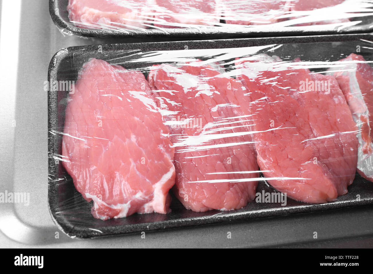 Packed pieces of beef meat on metal background Stock Photo - Alamy