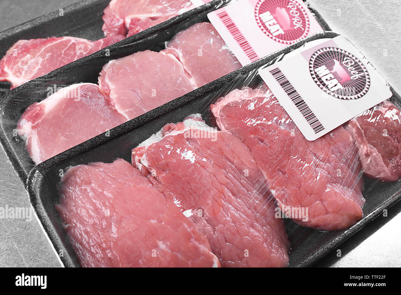 Packed pieces of pork and beef meat on metal background Stock Photo - Alamy