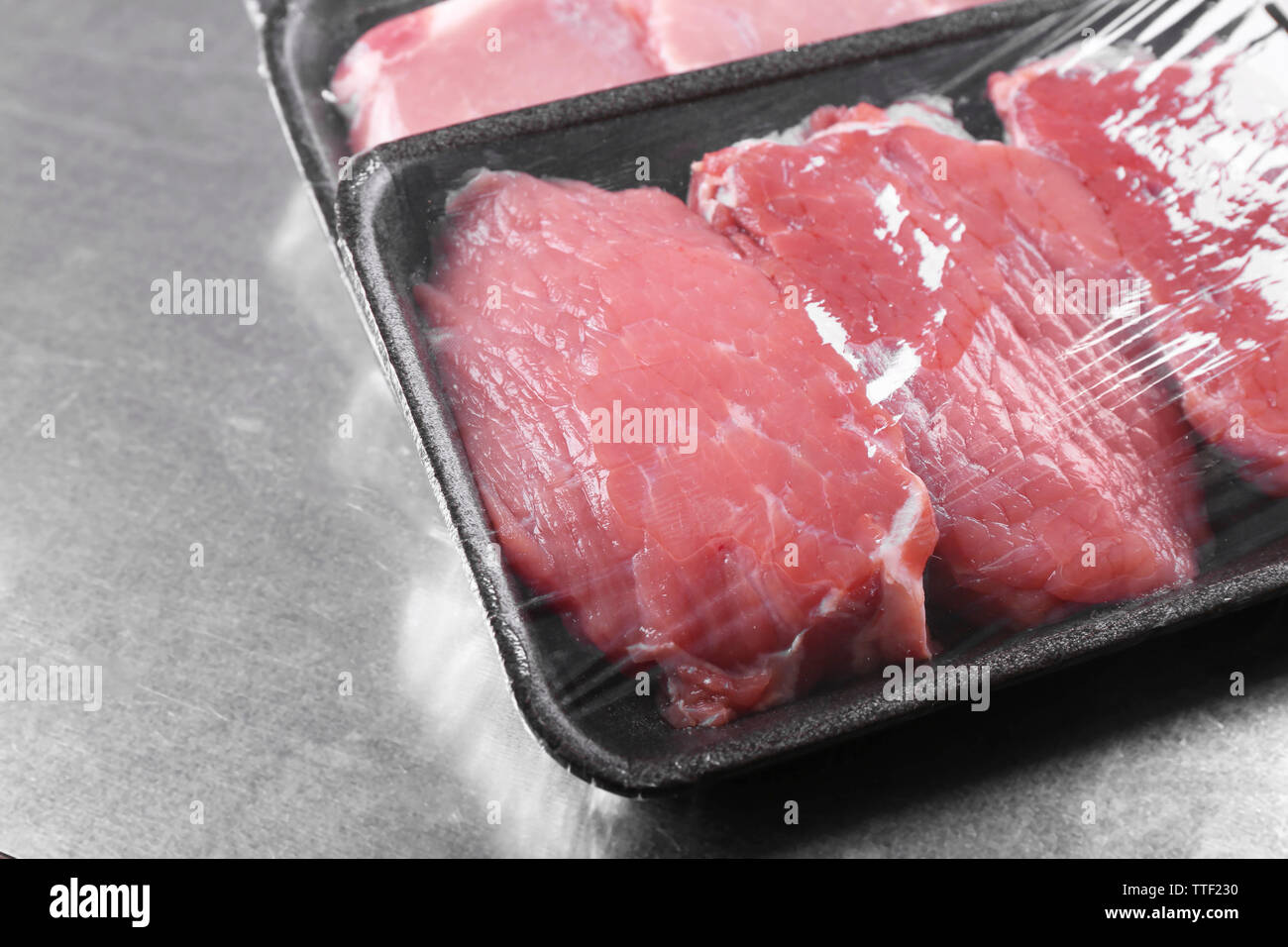 Packed pieces of beef meat on metal background Stock Photo - Alamy