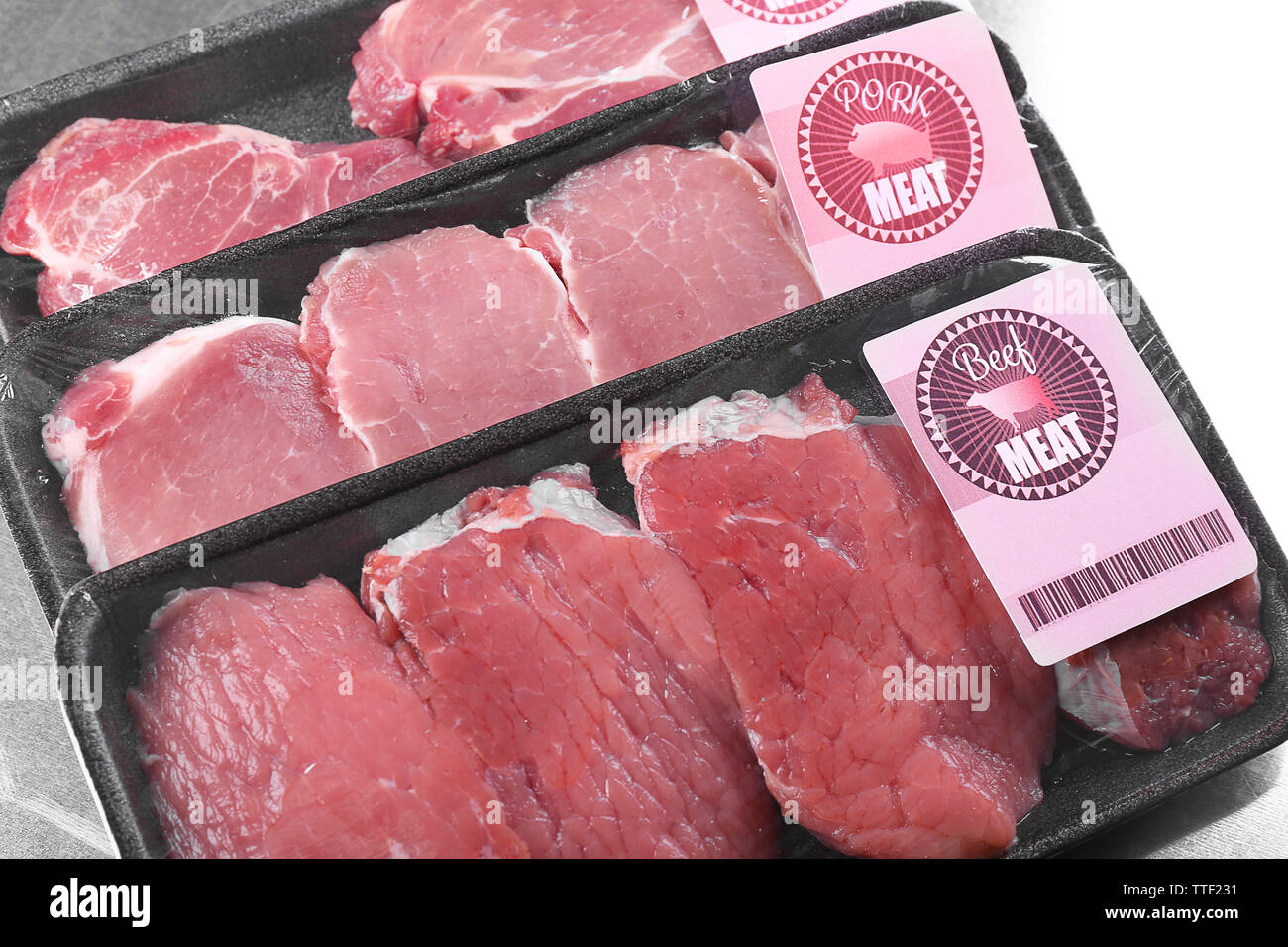 Packed pieces of pork and beef meat on metal background Stock Photo - Alamy