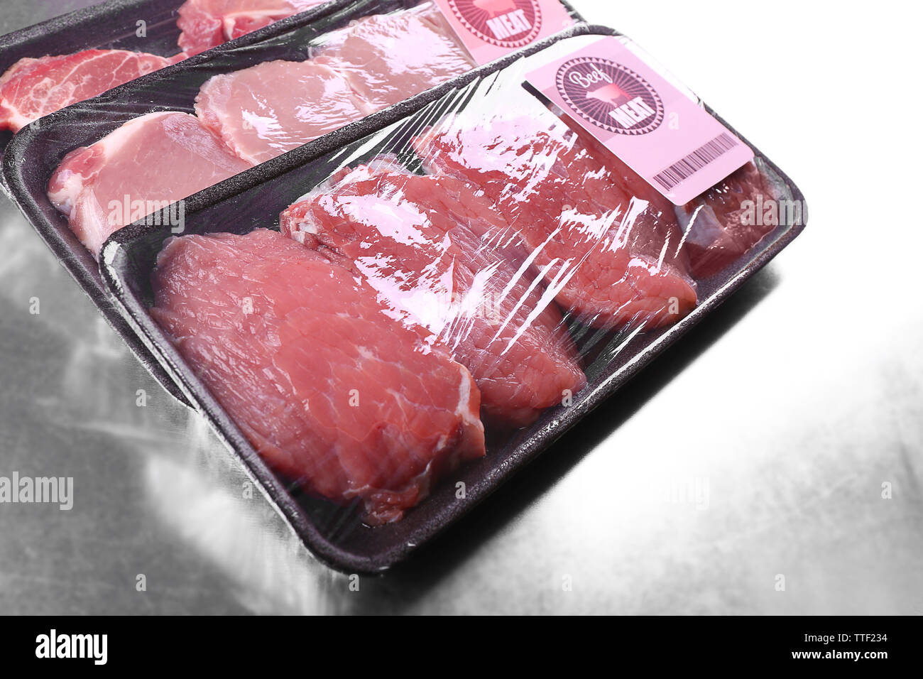 Packed pieces of beef meat on metal background Stock Photo - Alamy