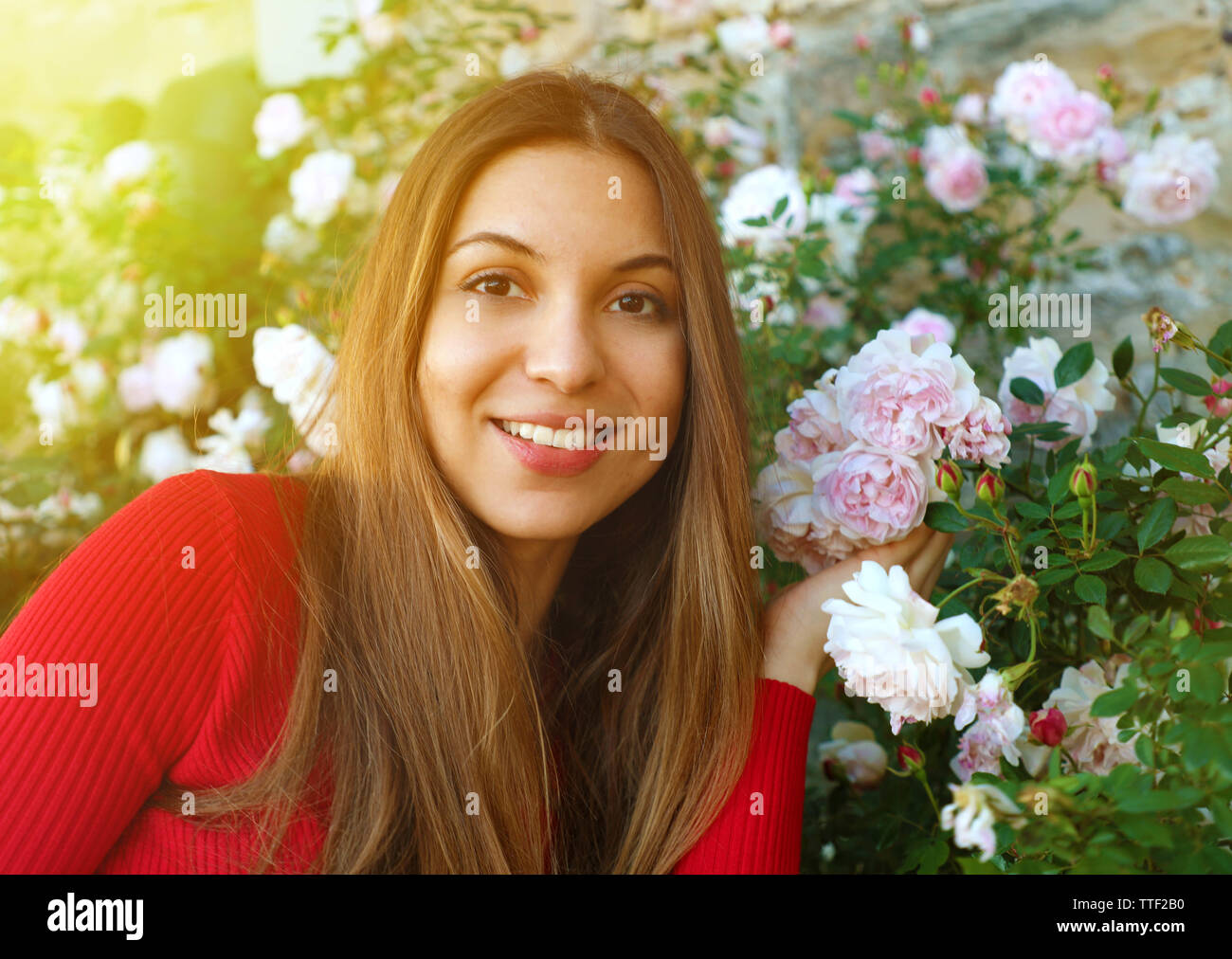 Close up of beautiful natural woman in the garden between roses Stock ...