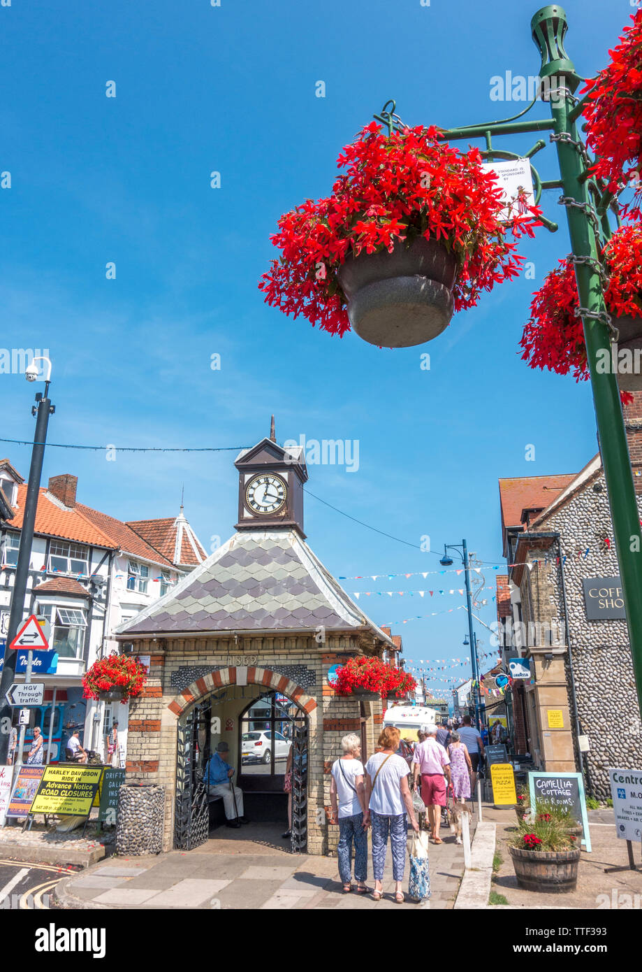 People walking in Sheringham town centre on a hot summer day, with the ...