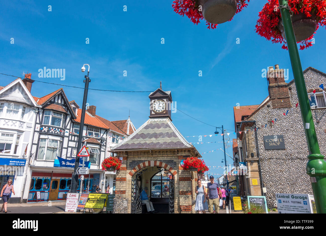 People walking in Sheringham town centre on a hot summer day, with the ...