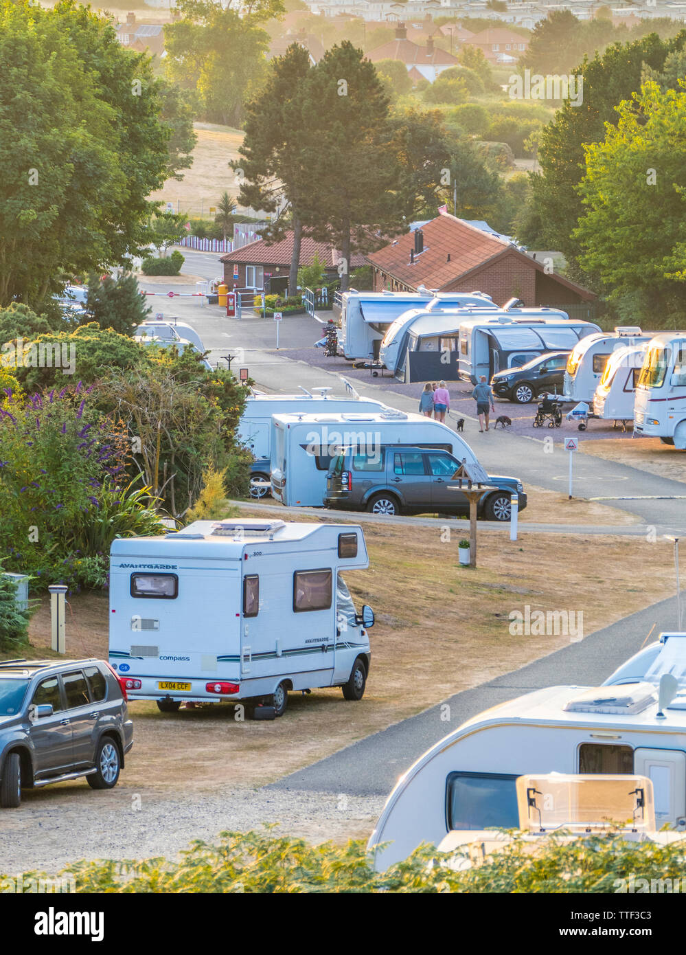 People walking through a peaceful Caravan and Motorhome Club site ...