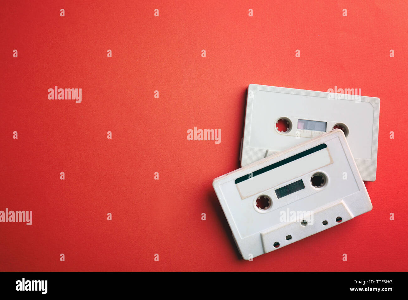 Old audio cassettes on red background Stock Photo - Alamy
