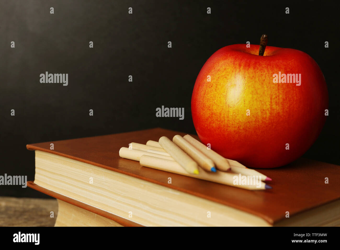 School books on desk near chalkboard Stock Photo - Alamy
