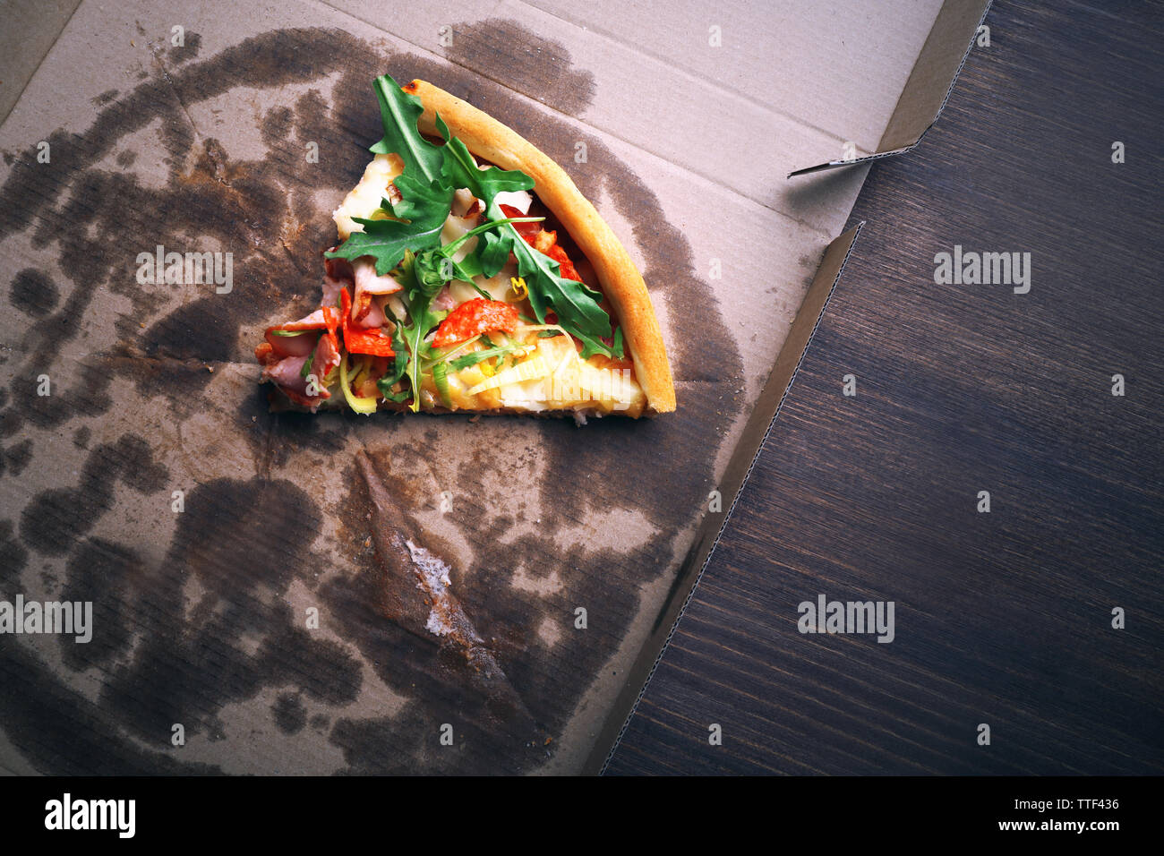 Piece of fresh pizza on cardboard background Stock Photo - Alamy