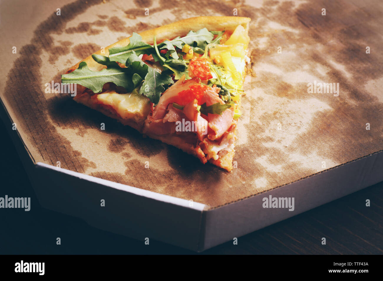 Piece of fresh pizza on cardboard background Stock Photo - Alamy