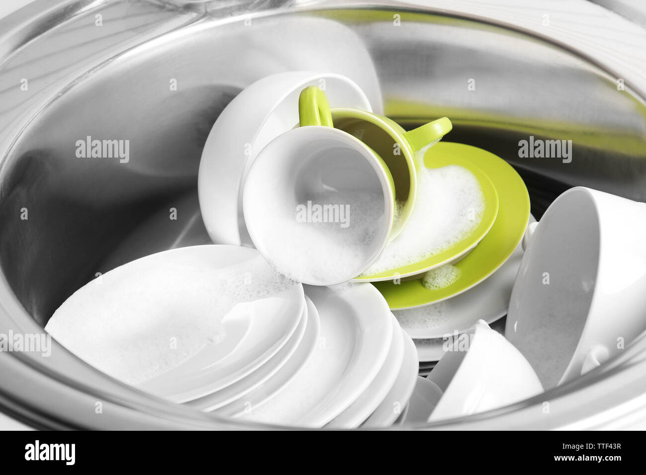 Pile of dishes in sink closeup Stock Photo - Alamy
