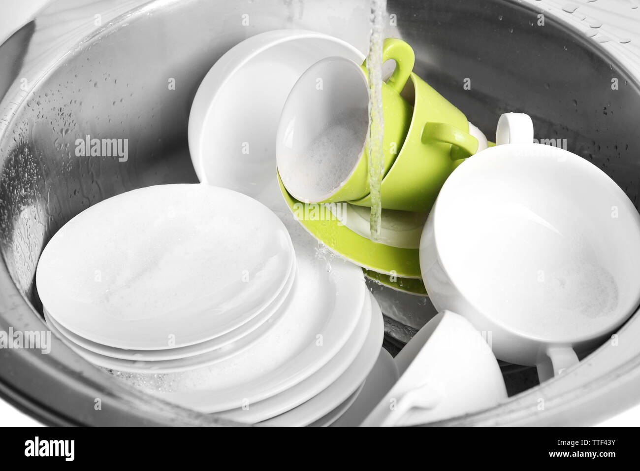 Pile of dishes in sink closeup Stock Photo - Alamy