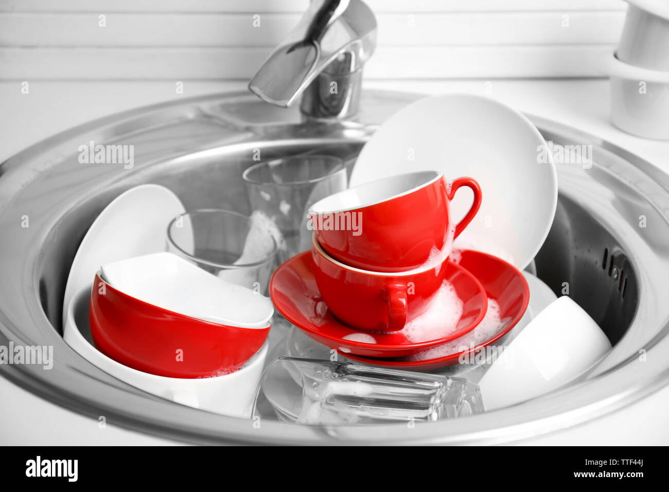 Pile of dishes in sink closeup Stock Photo - Alamy