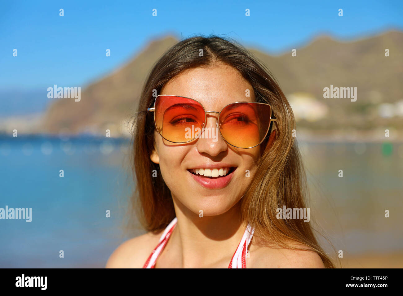 Portrait of young pretty woman with sunglasses on the beach Stock Photo ...