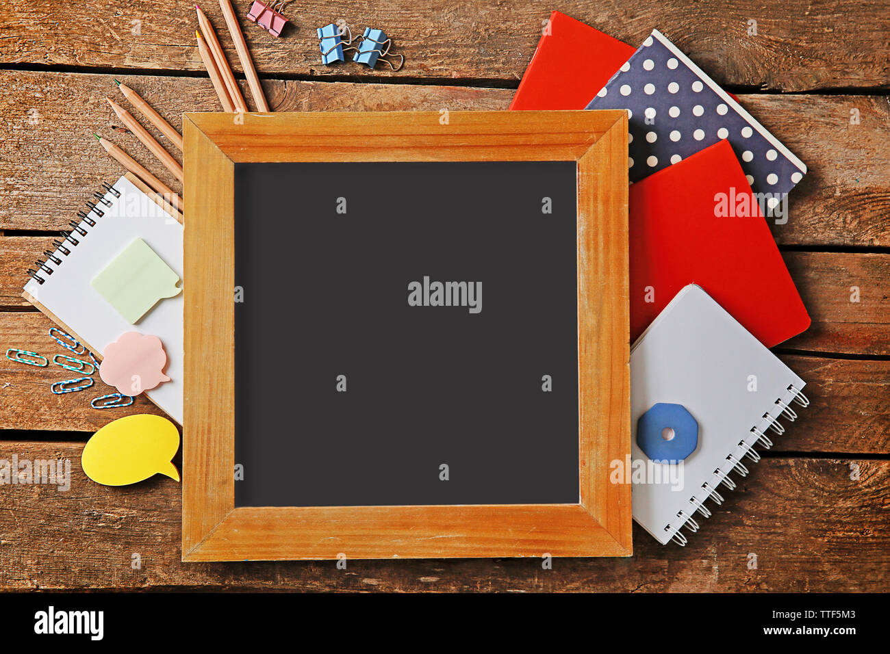 Small school blackboard with stationery on wooden background Stock ...