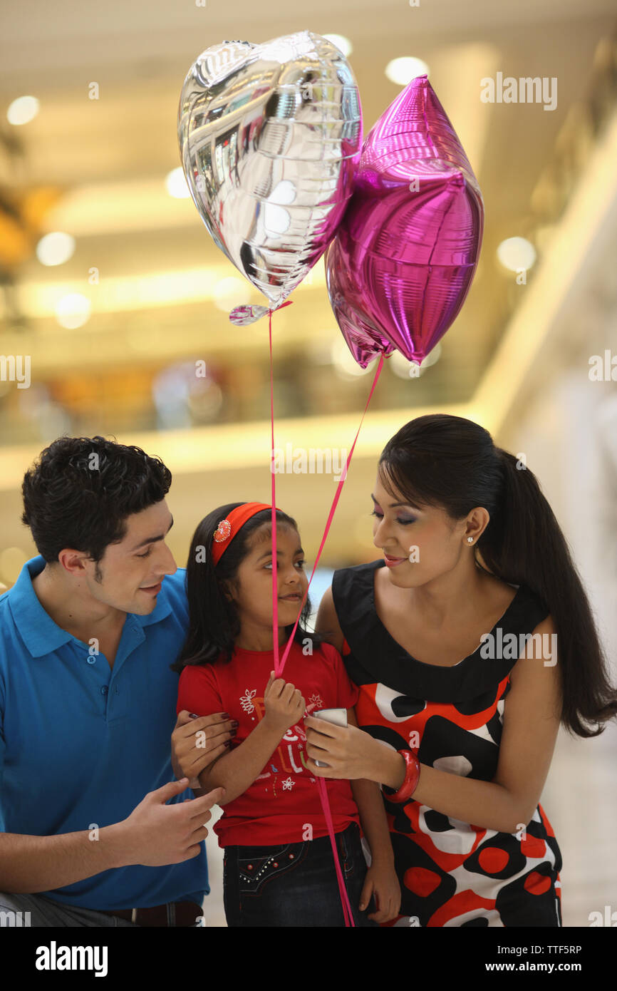 Girl with her parents in a shopping mall Stock Photo - Alamy