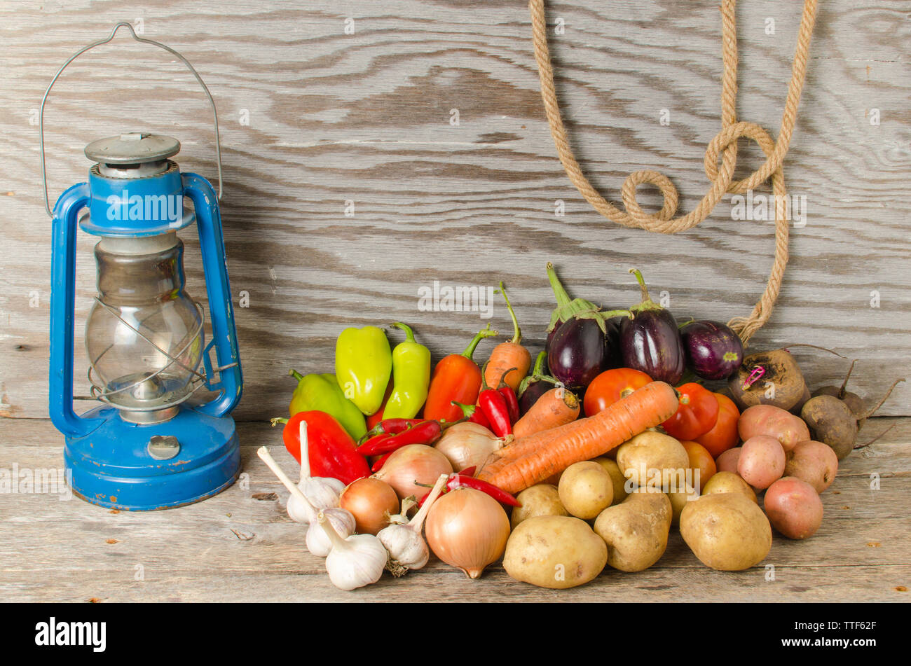 Vegetables on wooden background and a kerosene lamp, rope Stock Photo ...