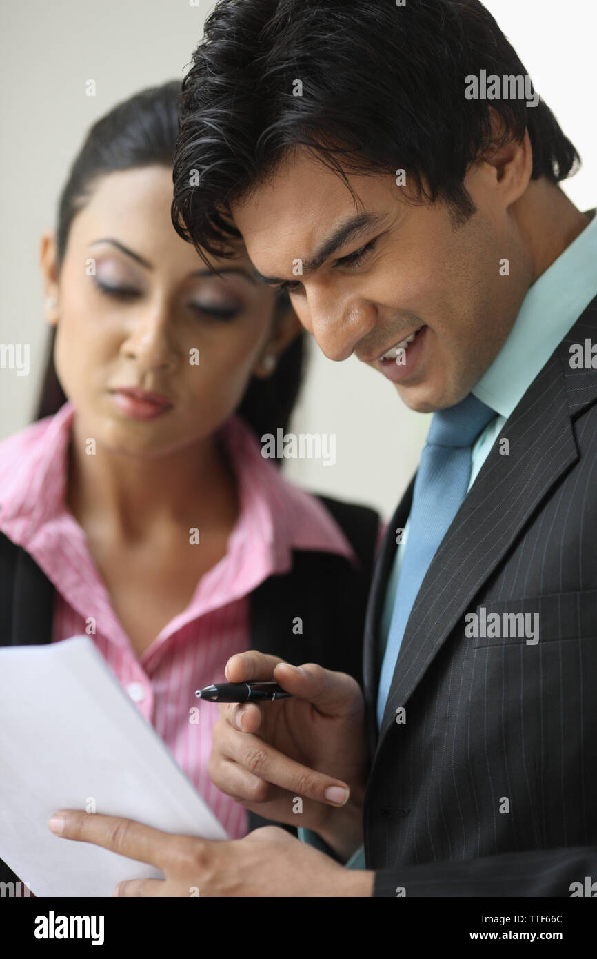 Indian two business executives going over documents Stock Photo - Alamy