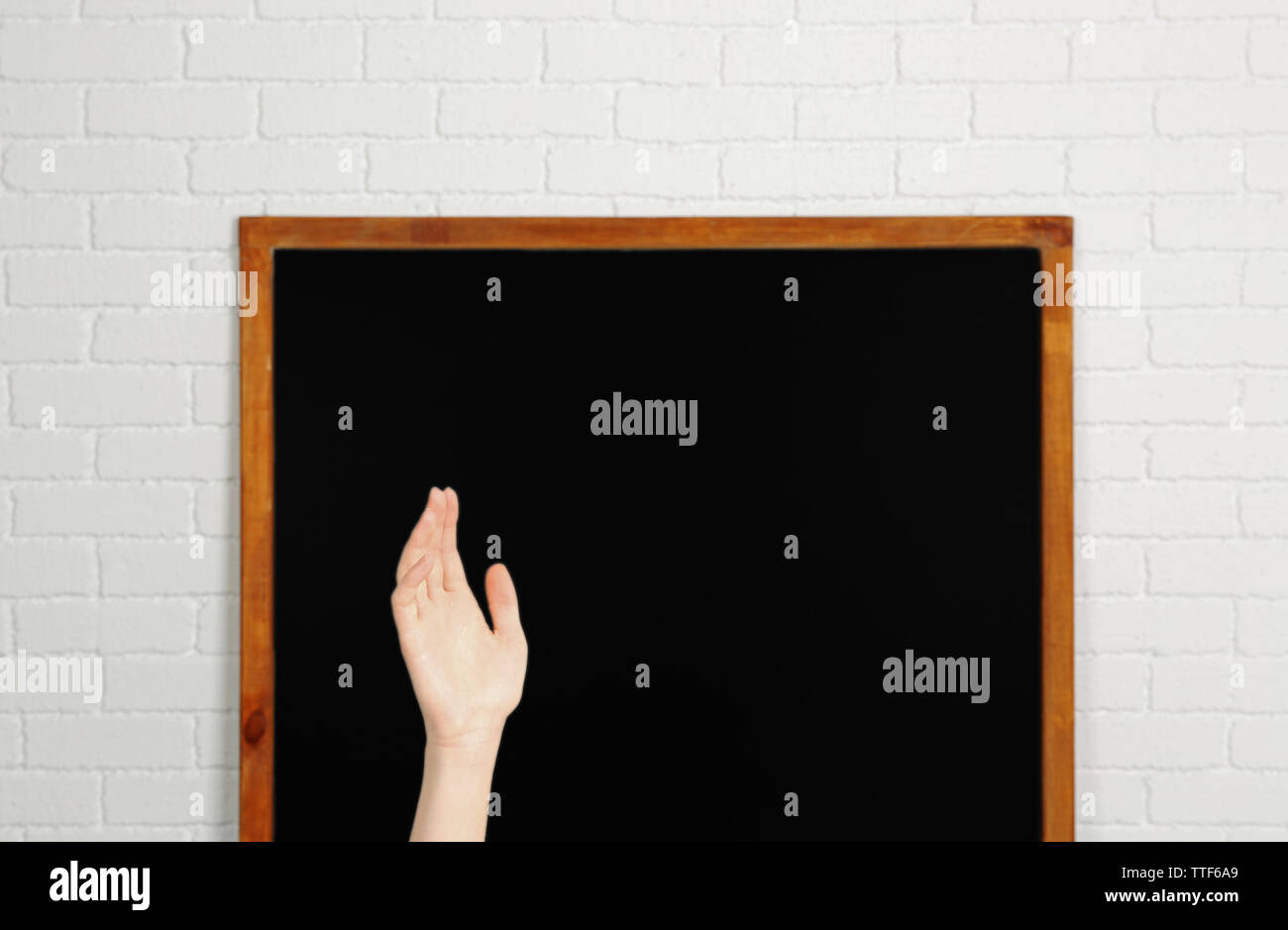 Raised hand on blackboard background in class Stock Photo - Alamy